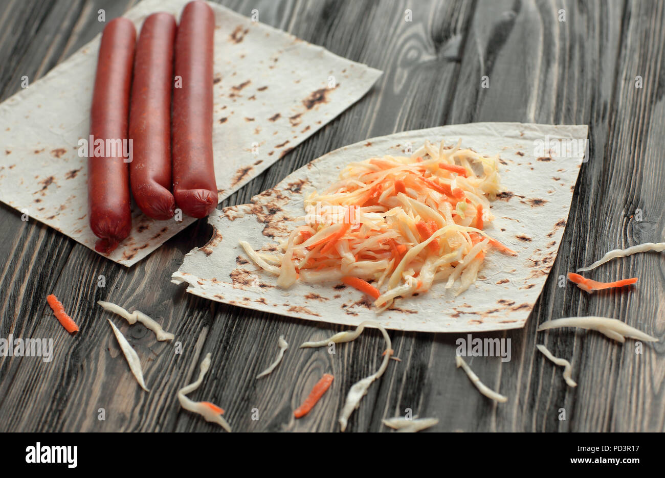 delicate sausages ,cabbage and pita bread on wooden background Stock ...