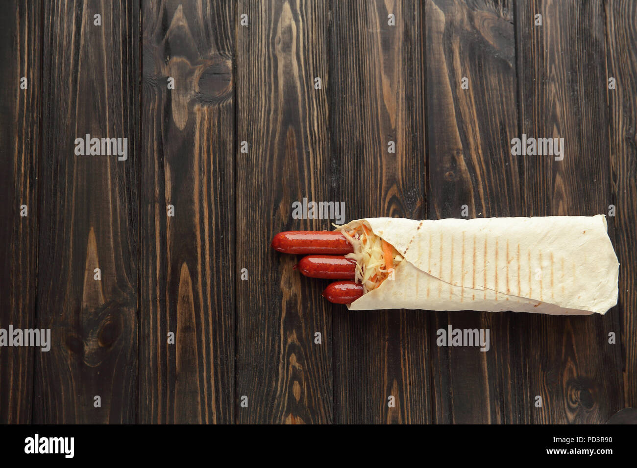 smoked sausage in pita bread on a dark wooden background.photo w Stock ...