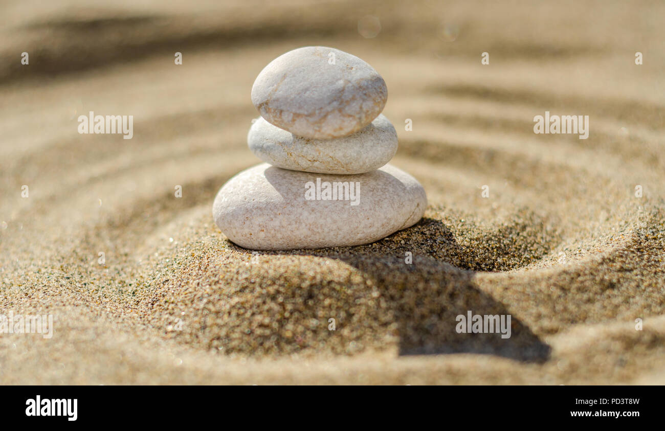 zen meditation stone in sand, concept for purity harmony and ...