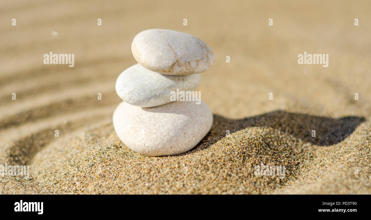 zen meditation stone in sand, concept for purity harmony and ...