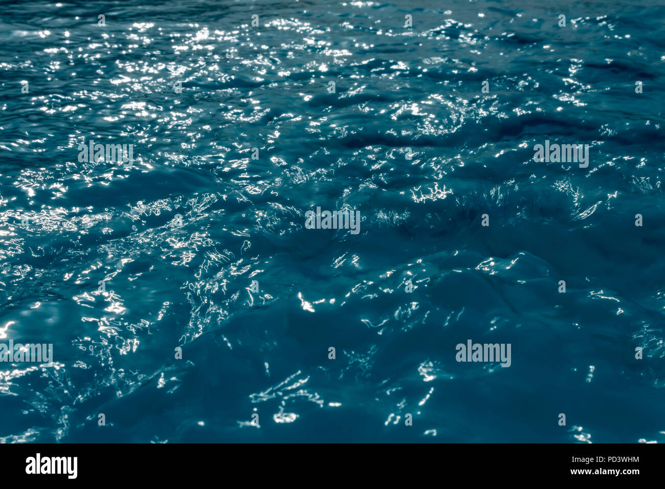 Water rippling with the sun's reflection shining on it Stock Photo - Alamy