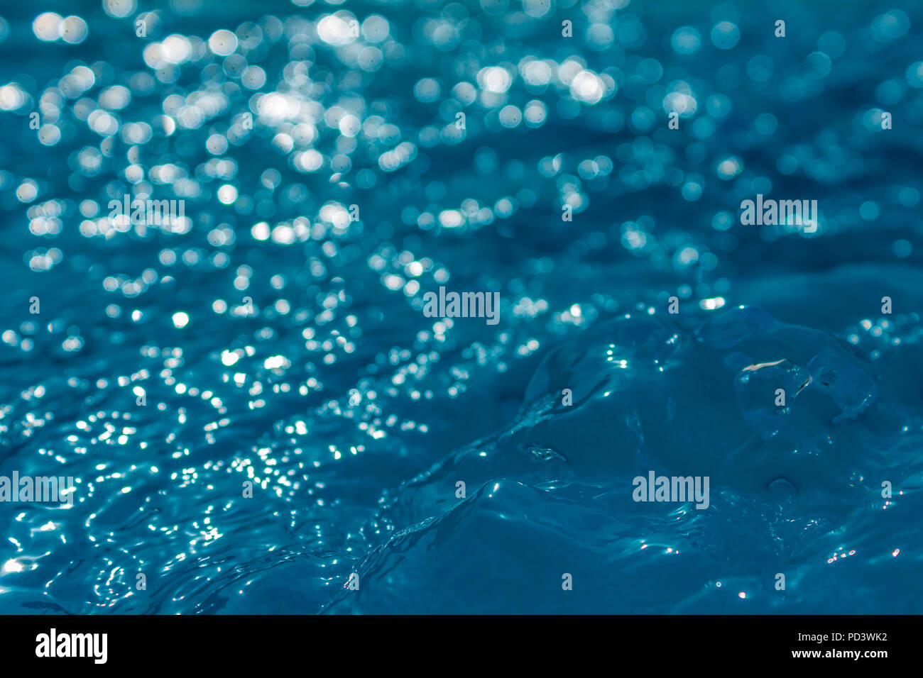 Water rippling with the sun's reflection shining on it Stock Photo - Alamy