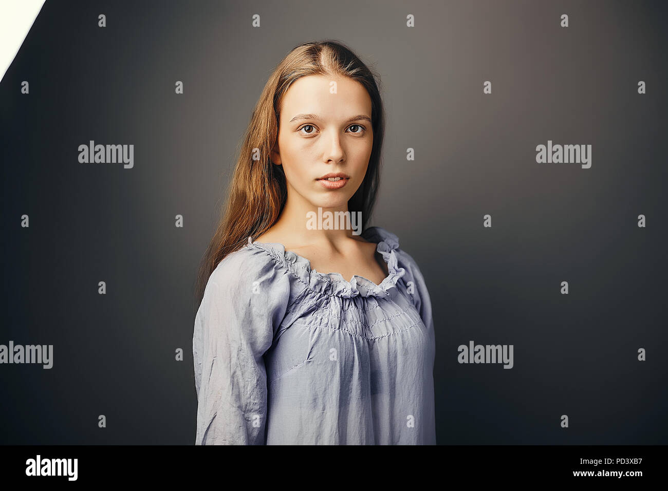 Young woman, grey background Stock Photo - Alamy
