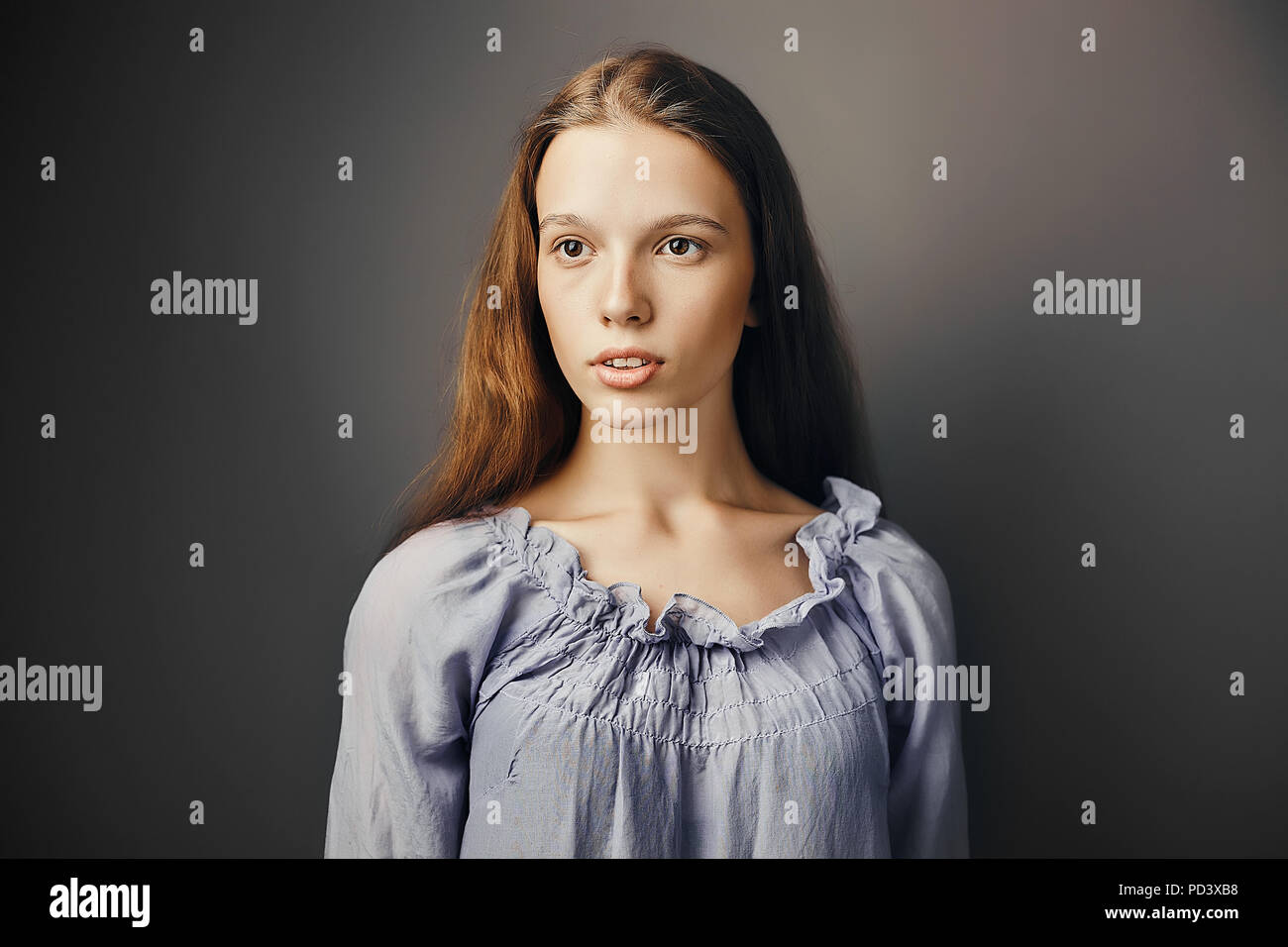 Young woman, grey background Stock Photo - Alamy