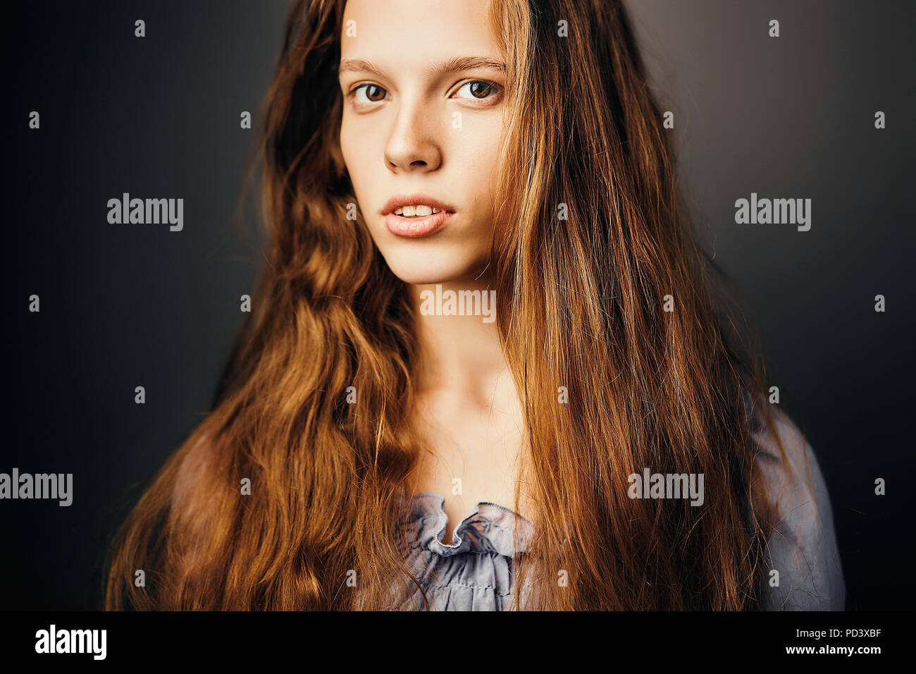 Young woman, grey background Stock Photo - Alamy