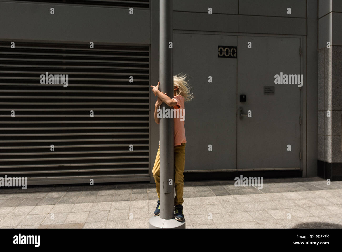 Boy hugging lamp post on day trip in Toronto, Canada Stock Photo - Alamy