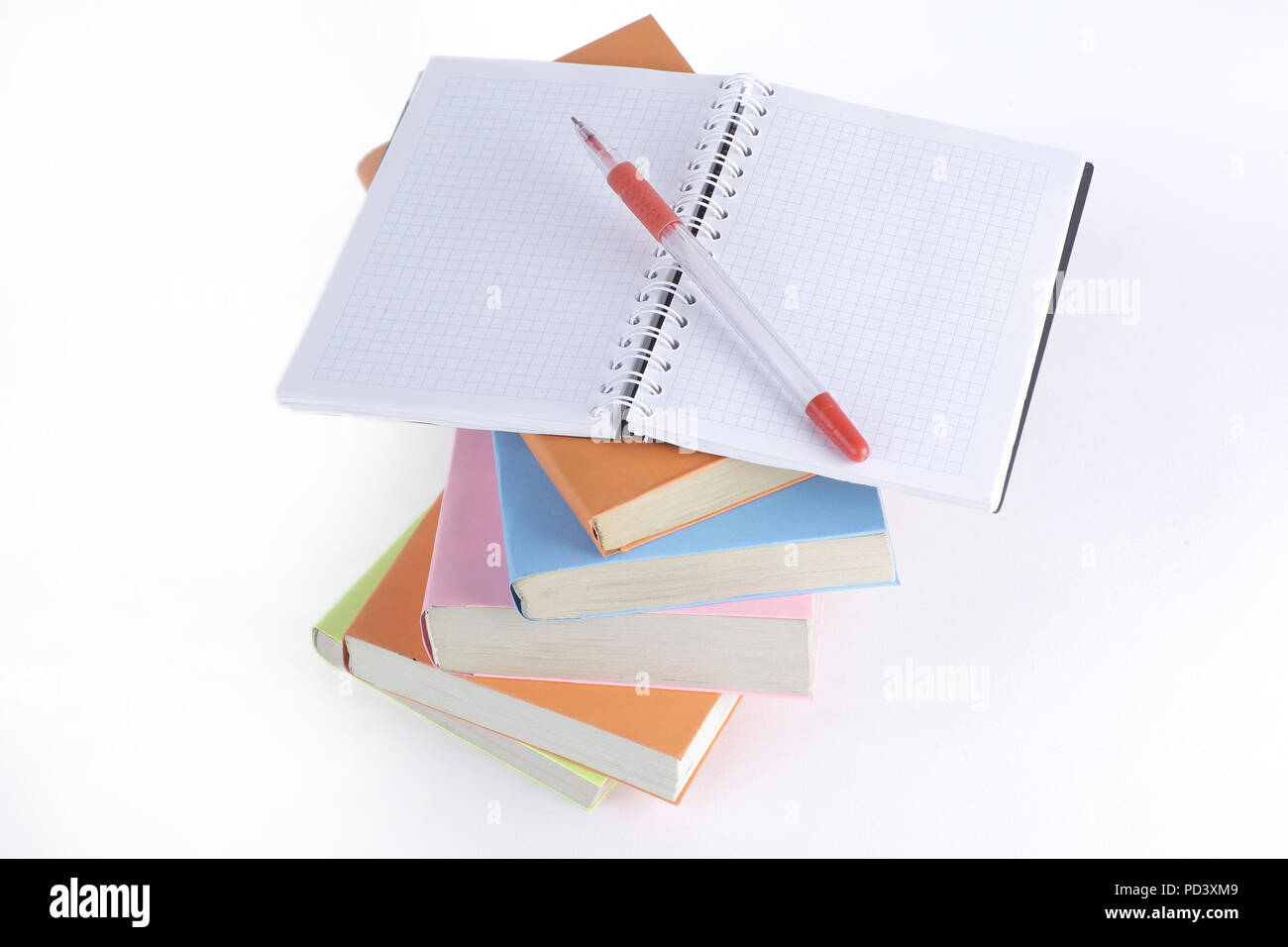 open the notebook, pen and a stack of books on white background Stock ...