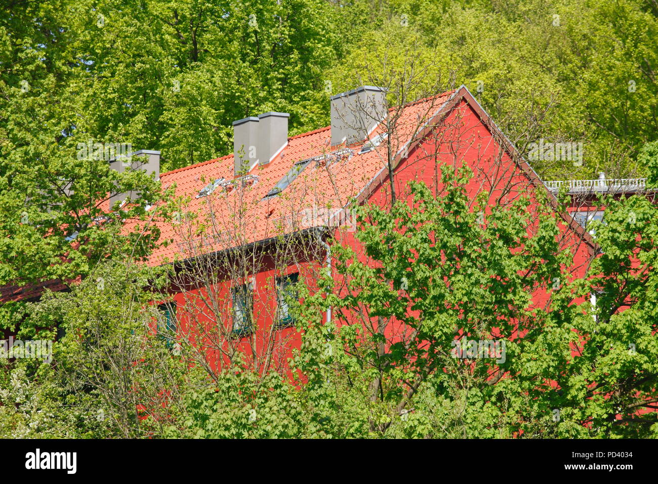 Red Residential Building house in the green with plants Stock Photo - Alamy