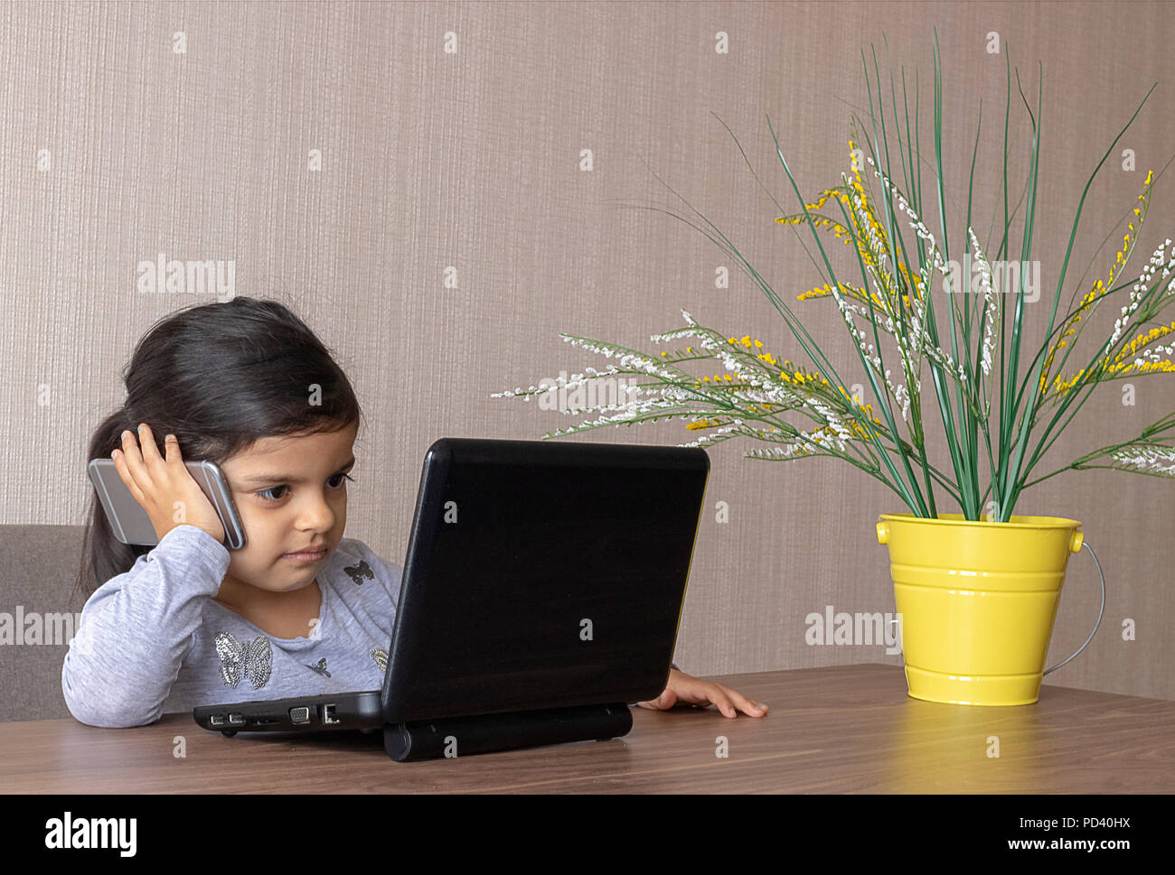 Cute little girl working in the office Stock Photo - Alamy
