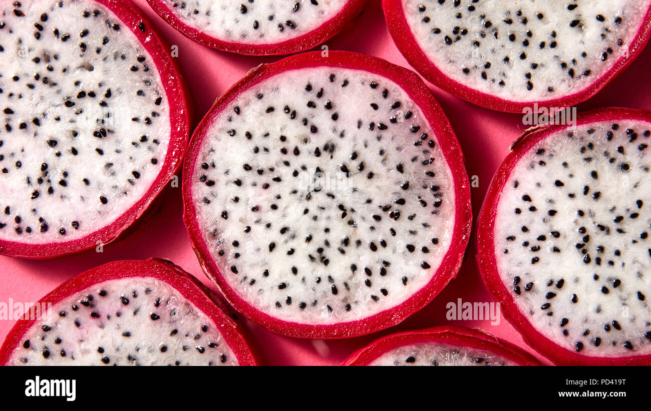 Flat lay view of background from round slices of Dragon fruit or Pitaya ...