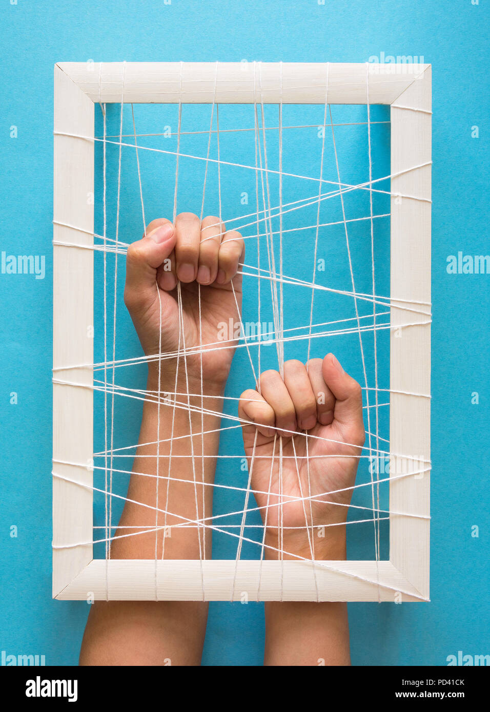 Mental health concept. Women's hands try to break the fetters on blue ...