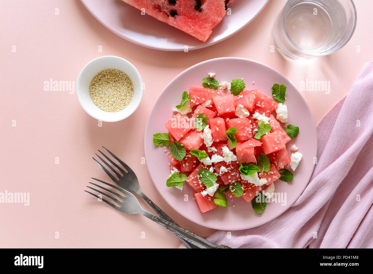 Summer watermelon salad with feta cheese, sesame seeds and mint leaves ...