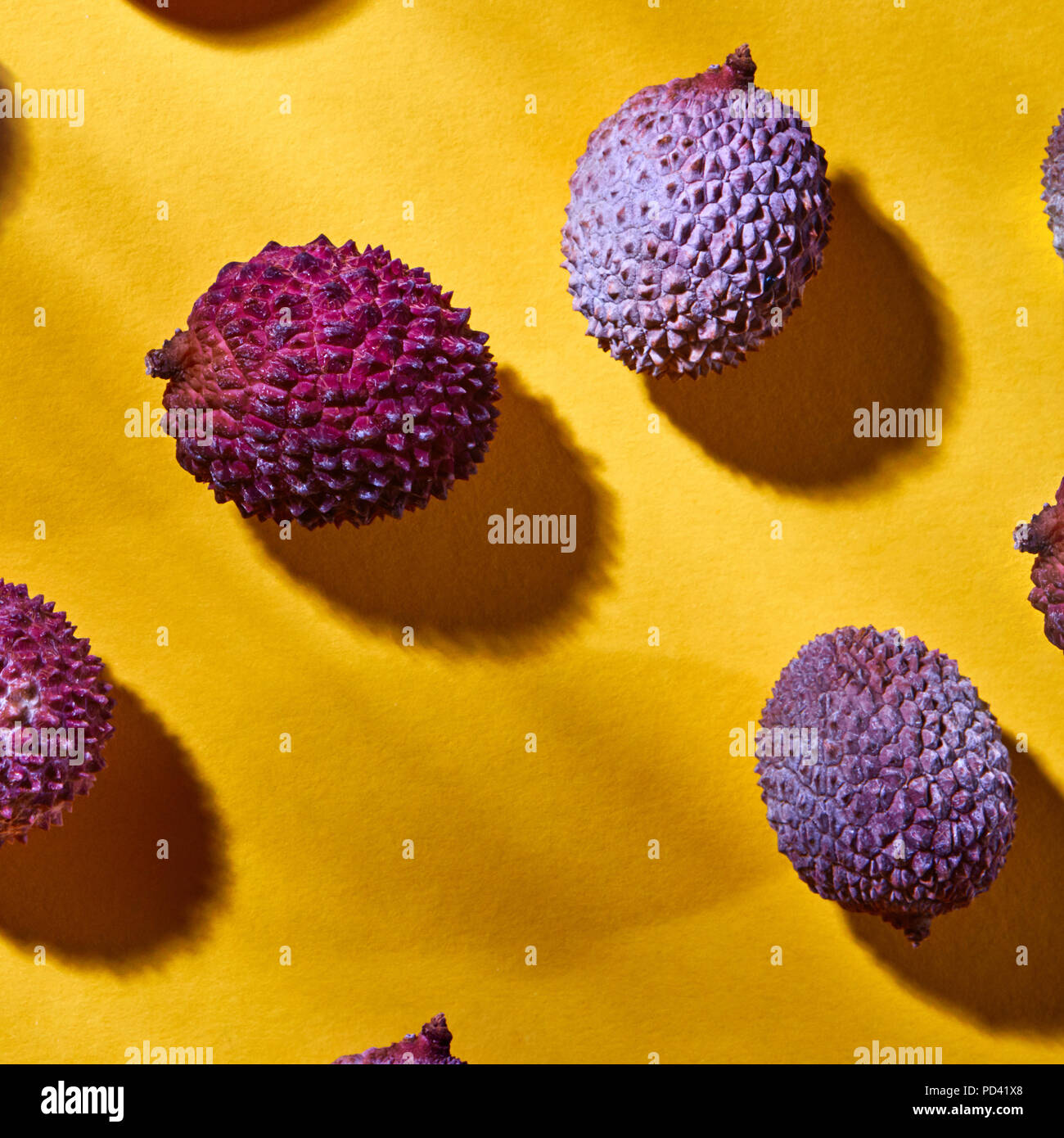 Top view of tropical litchi fruit on a yellow background with hard ...