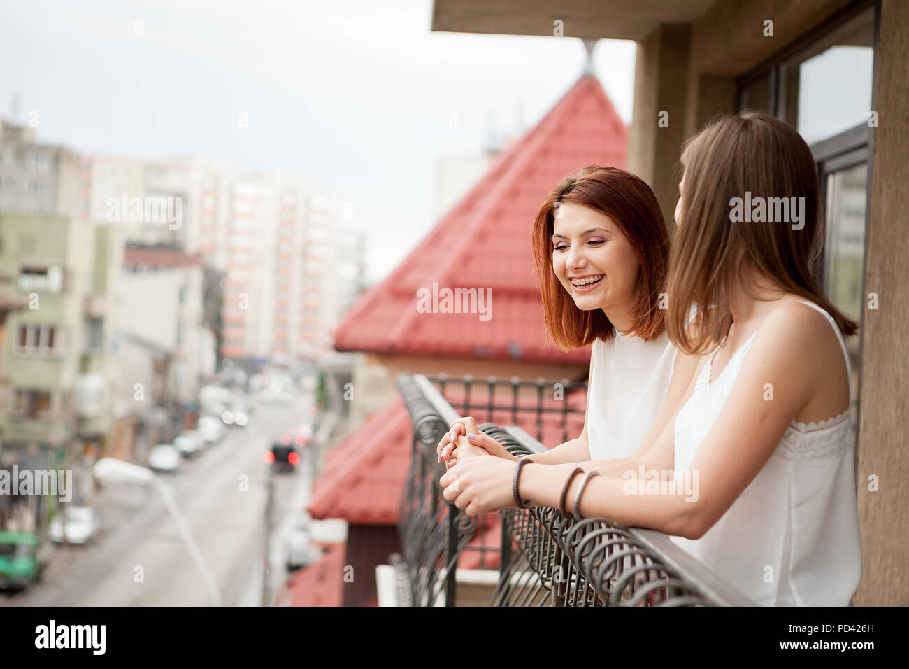 Two people balcony apartment hi-res stock photography and images - Alamy