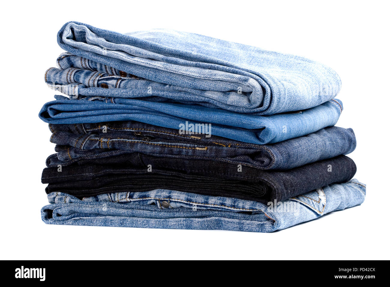 stack of blue jeans isolated on white background Stock Photo - Alamy