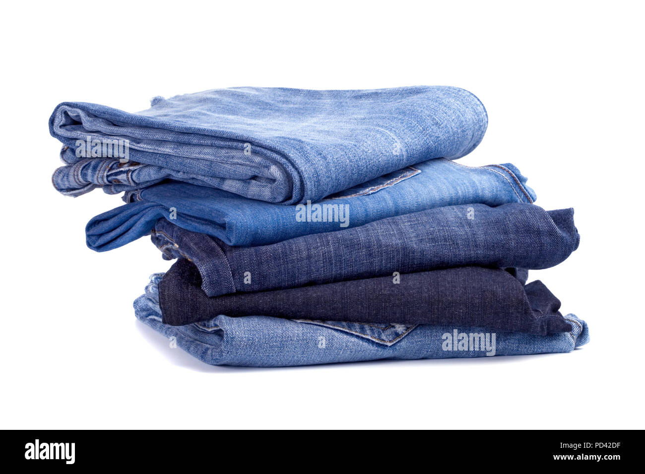 stack of blue jeans isolated on white background Stock Photo - Alamy