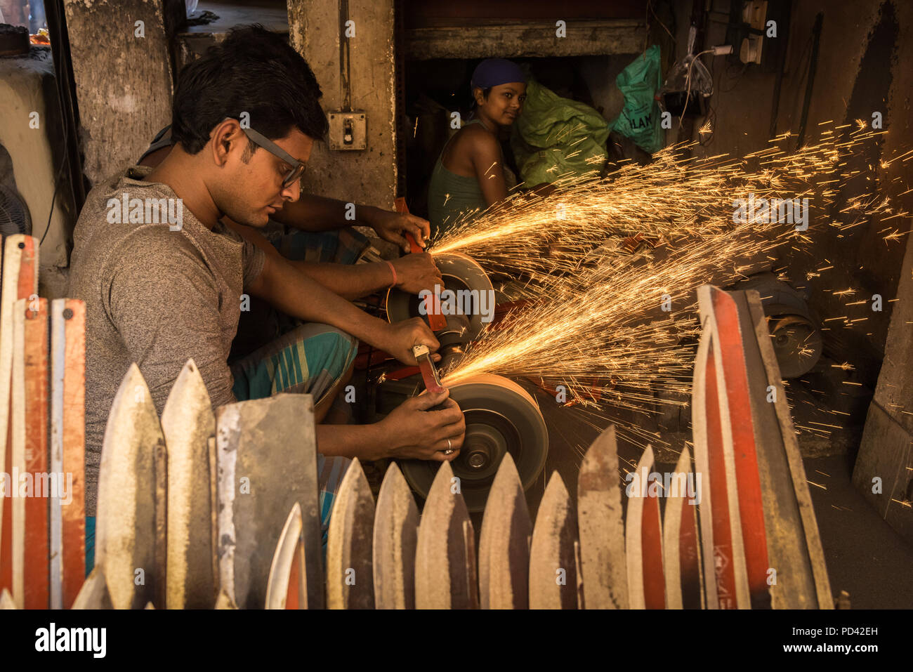 Men producing knife blades in an open air shop in Kolkata, India Stock ...