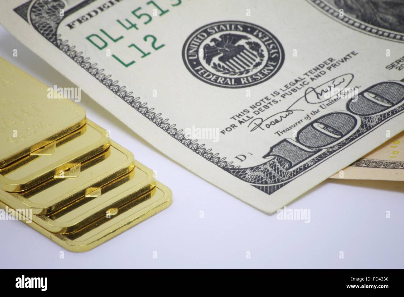 Gold bar ingot close up on the US money dollar background Stock Photo ...