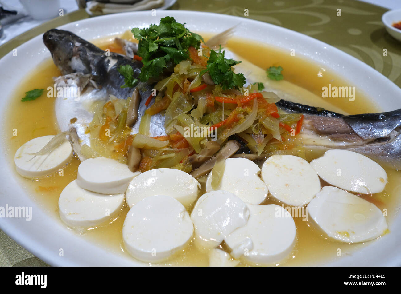 Patin silver catfish steamed with chinese style soya sauce and ginger ...