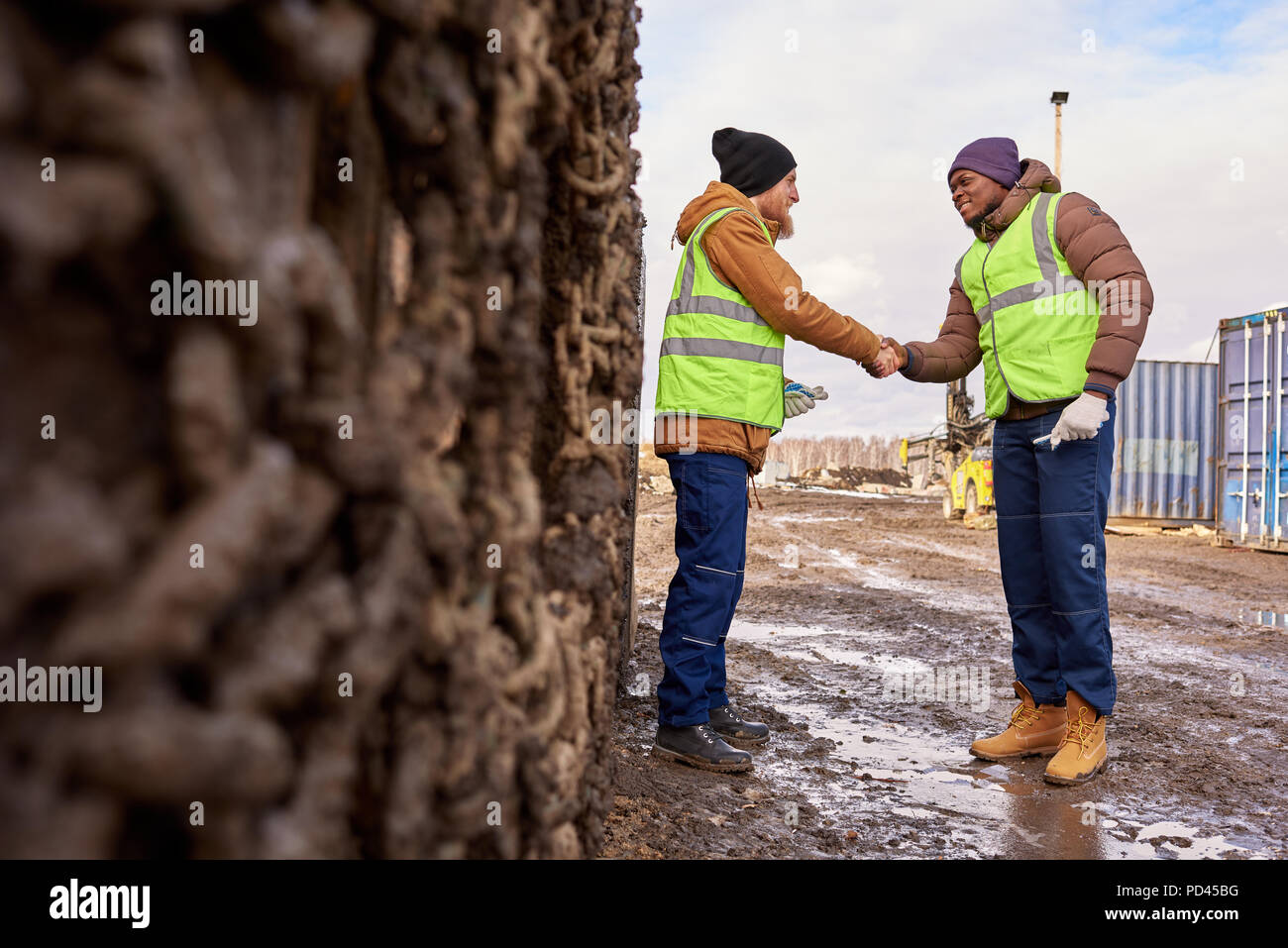 Two Workers Shaking Hands Stock Photo - Alamy