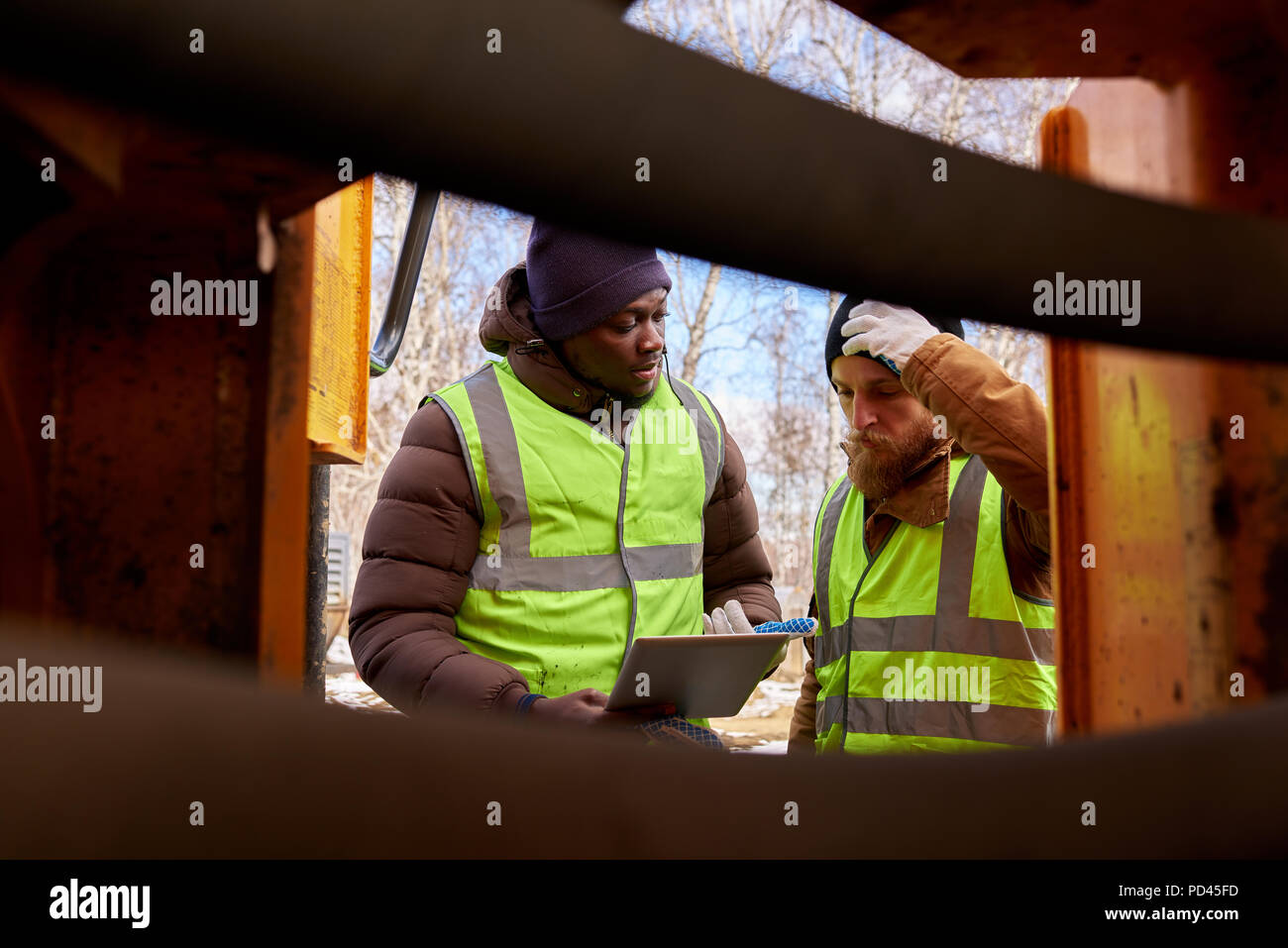 Two Miners Inspecting Vehicle Stock Photo - Alamy