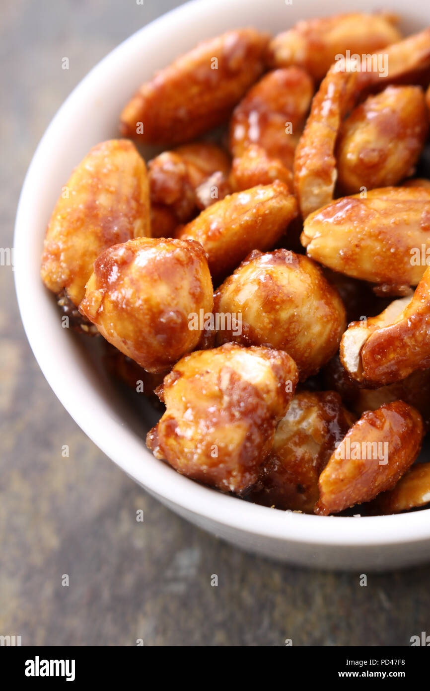flavoured caramelised mixed nut snacks Stock Photo - Alamy