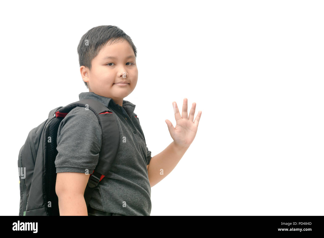 Asian boy student going to school and waving goodbye isolated on white ...