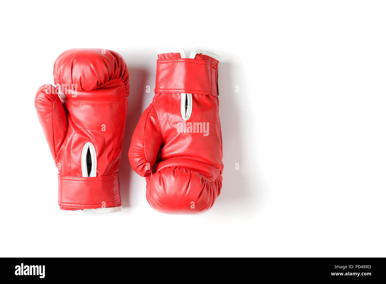 Pair of red leather boxing gloves isolated on white, top view and sport ...
