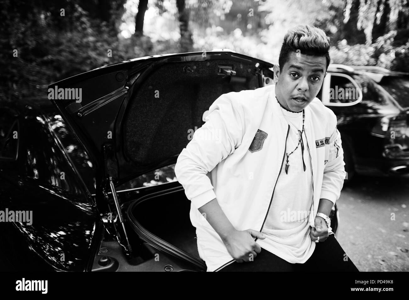 Stylish hipster arab man guy posed outdoor in street and sitting on the ...