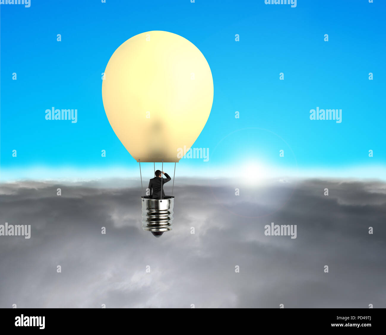 Man taking glowing lamp balloon flying over clouds with sun and blue ...