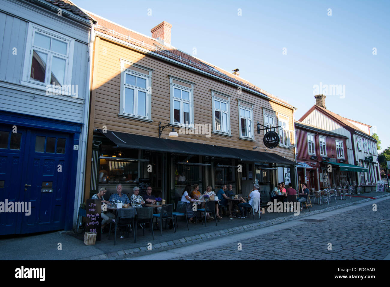 Trondheim Norway restaurant people sitting outside wood buildings sign ...