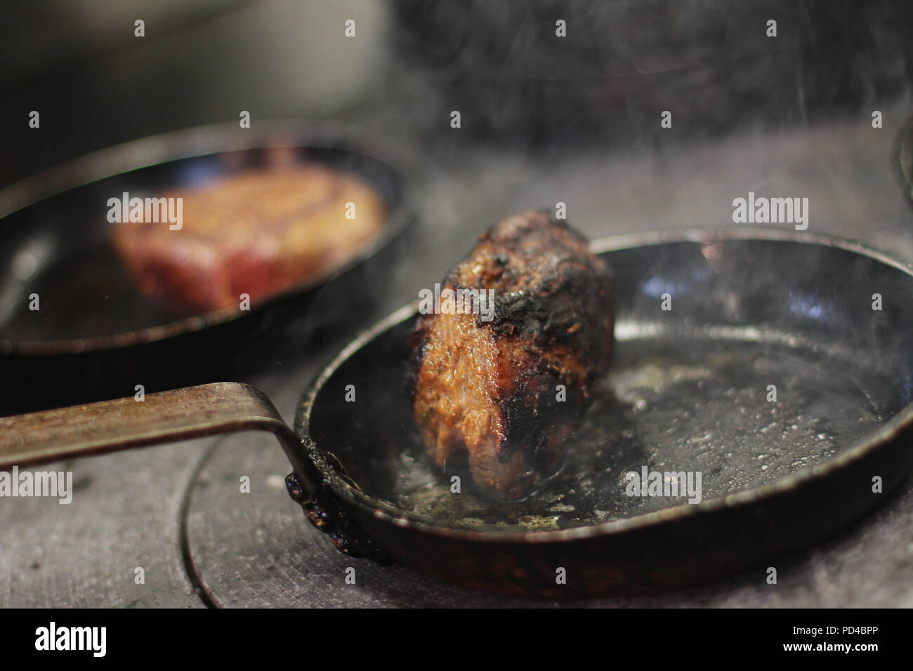 cooking meat on stove Stock Photo - Alamy