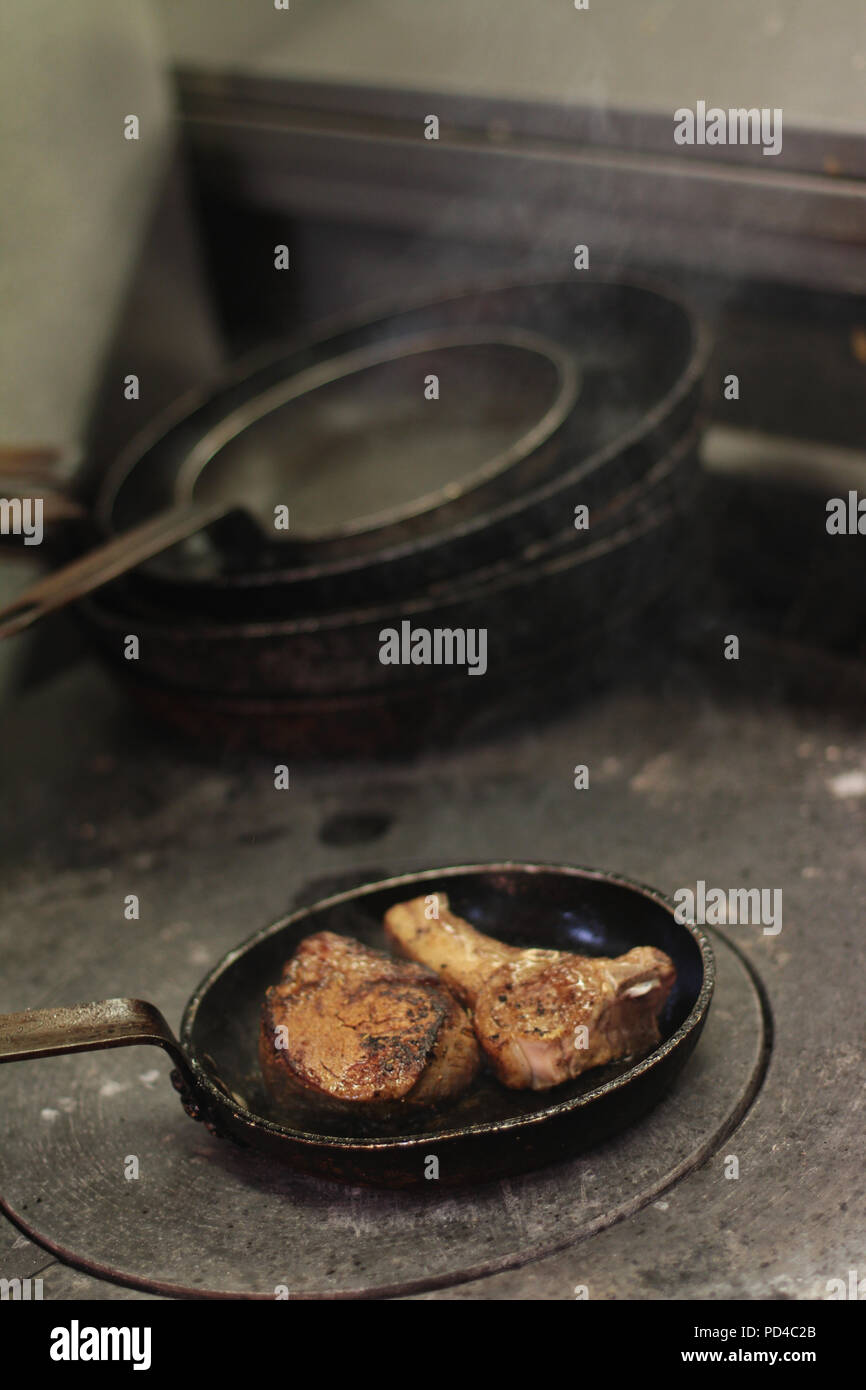 cooking meat on stove Stock Photo - Alamy