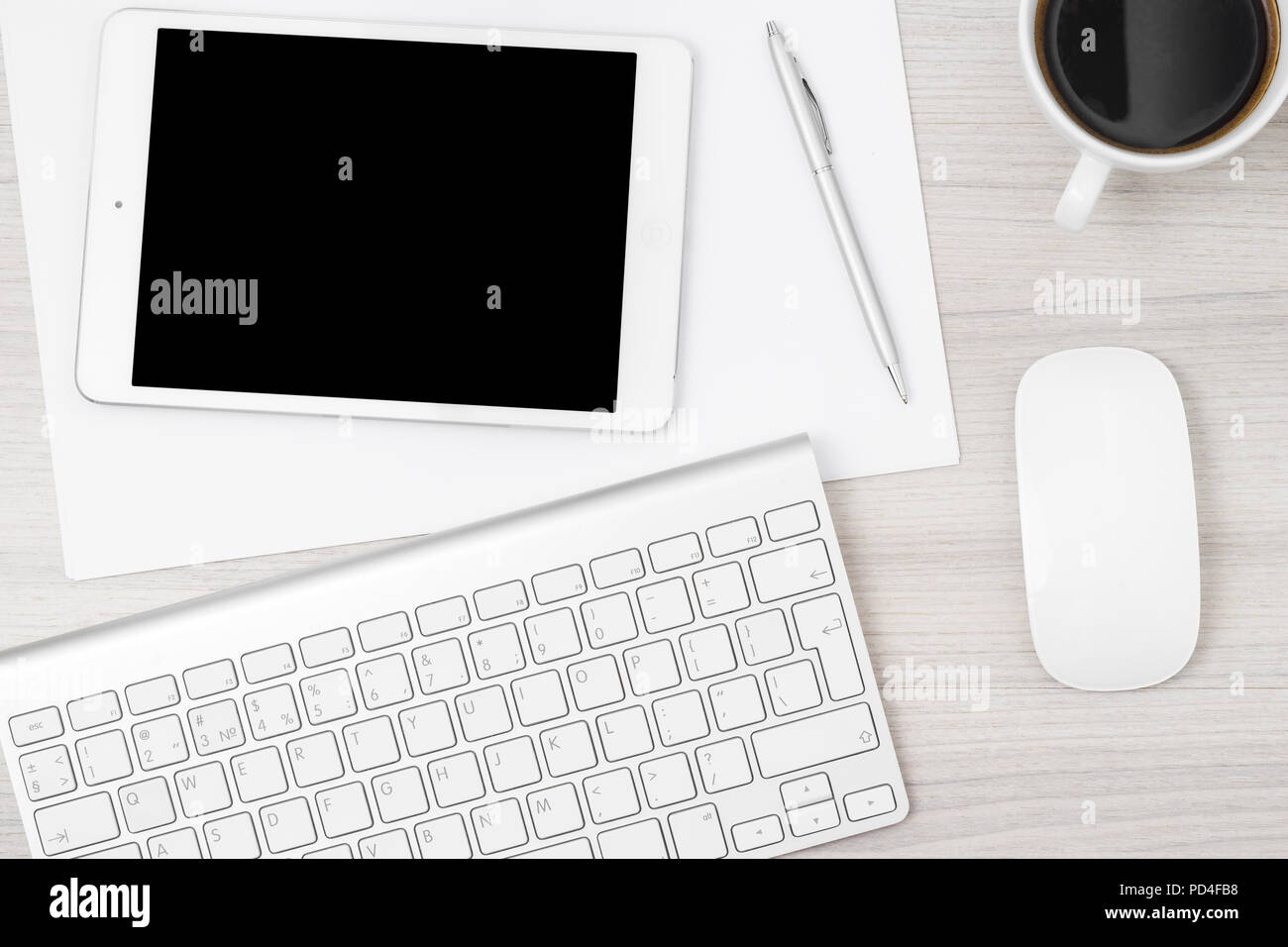 Tablet computer on the white table Stock Photo - Alamy