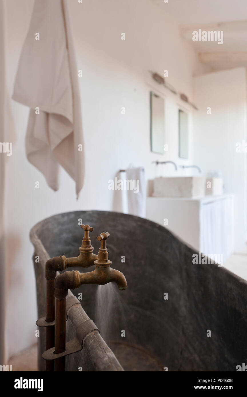 Metal bath in rustic bathroom Stock Photo - Alamy