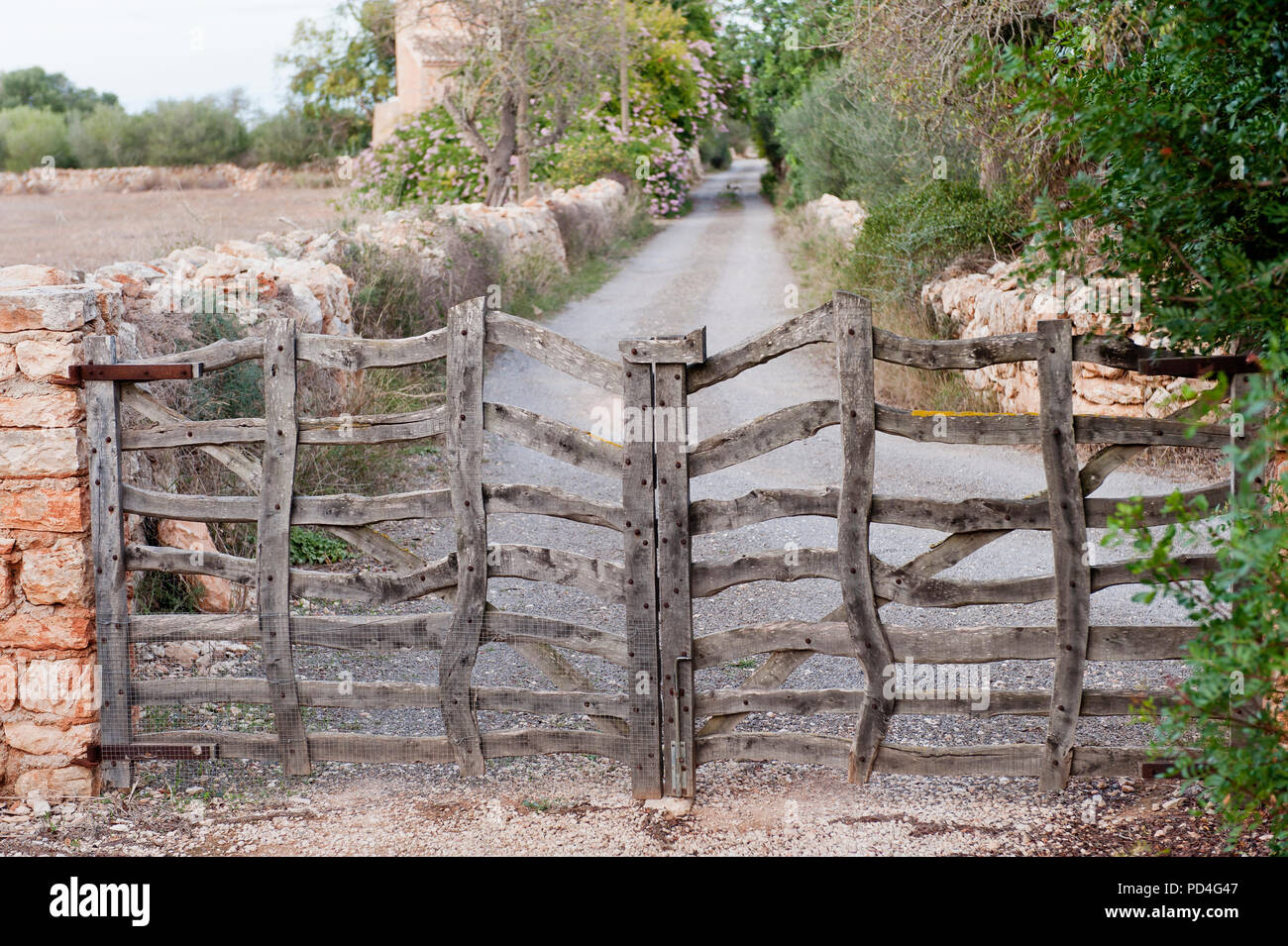 Closed gate on driveway Stock Photo - Alamy