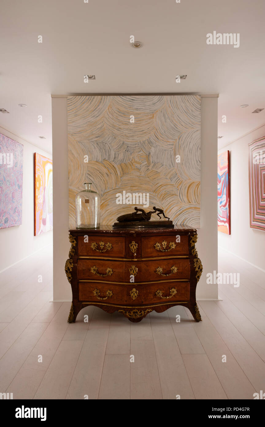 Antique drawers and paintings in hallway Stock Photo - Alamy