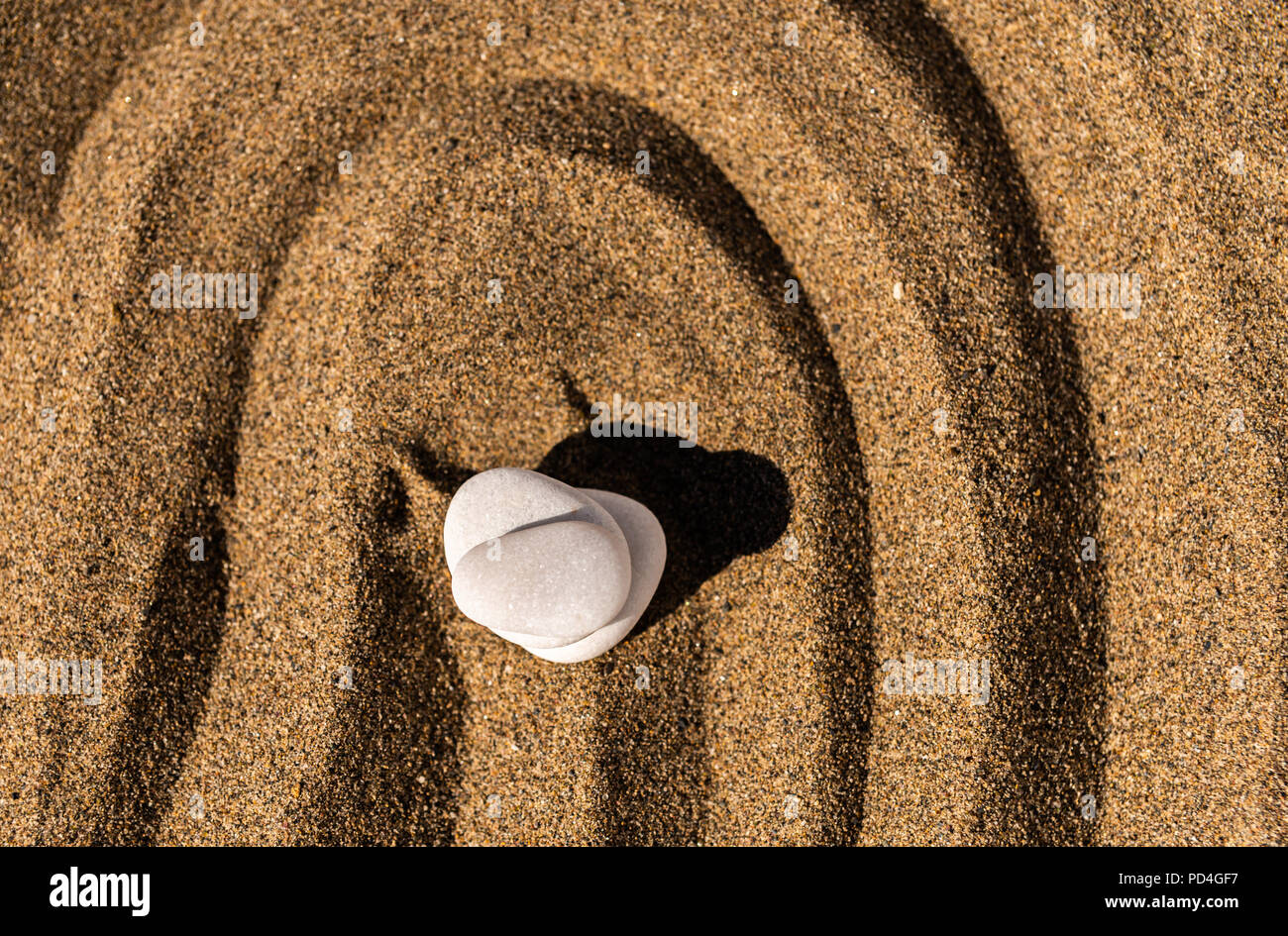 zen meditation stone in sand, concept for purity harmony and ...