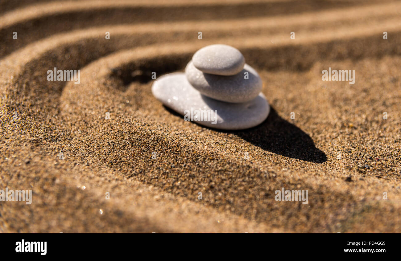 zen meditation stone in sand, concept for purity harmony and ...
