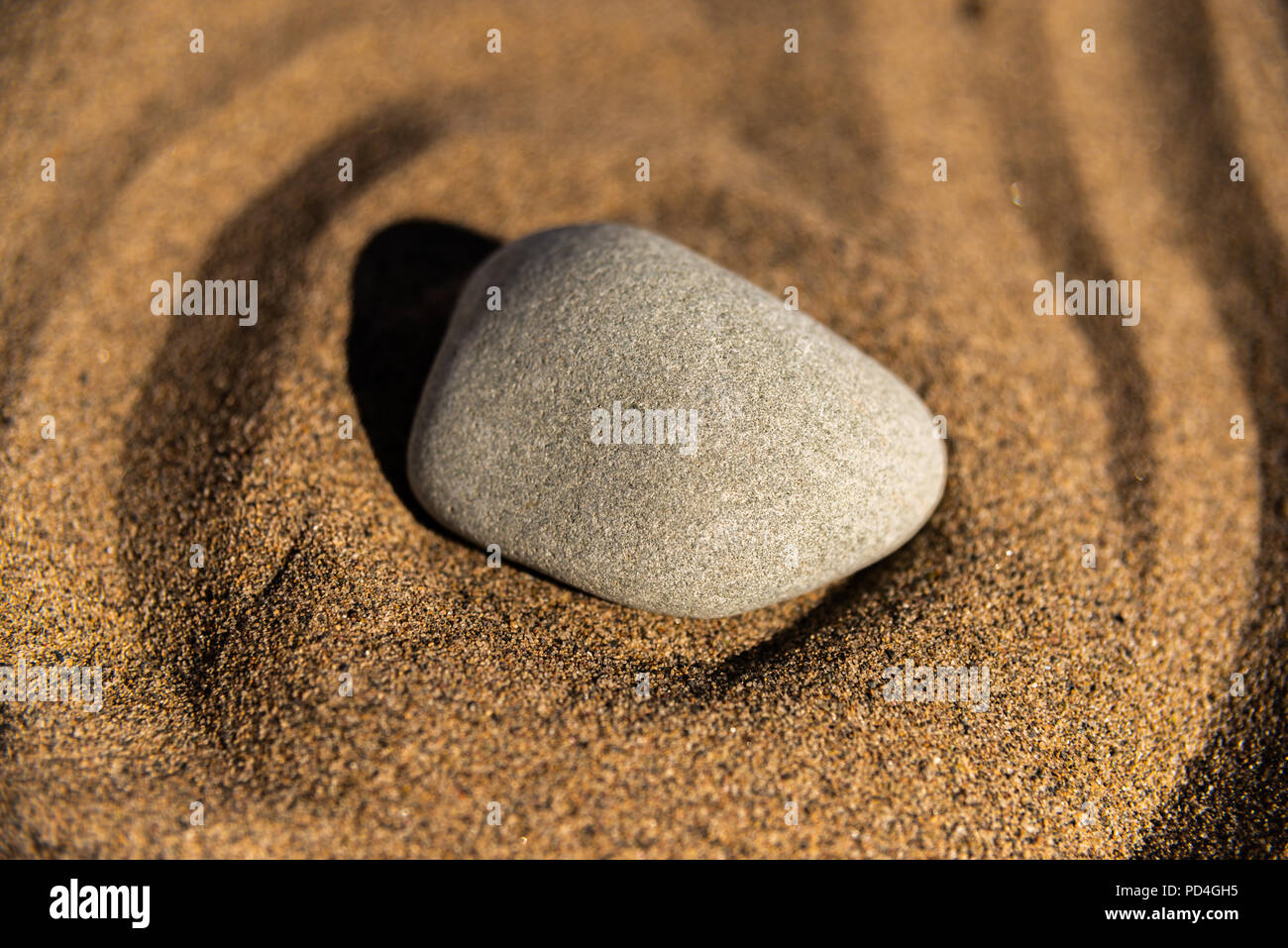 zen meditation stone in sand, concept for purity harmony and ...