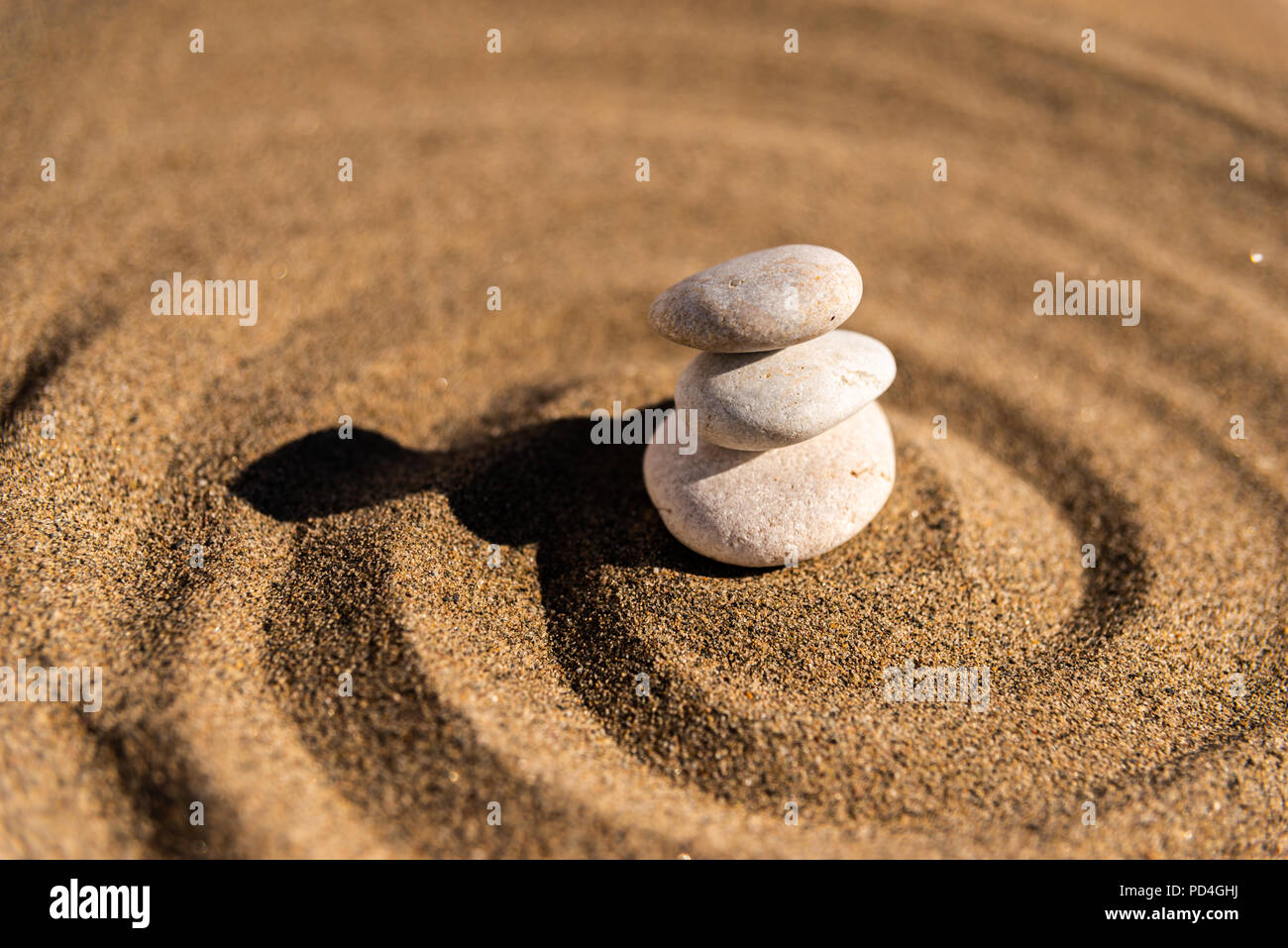 zen meditation stone in sand, concept for purity harmony and ...
