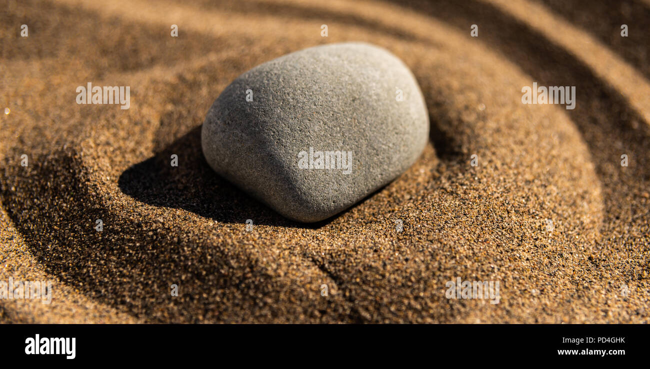 zen meditation stone in sand, concept for purity harmony and ...