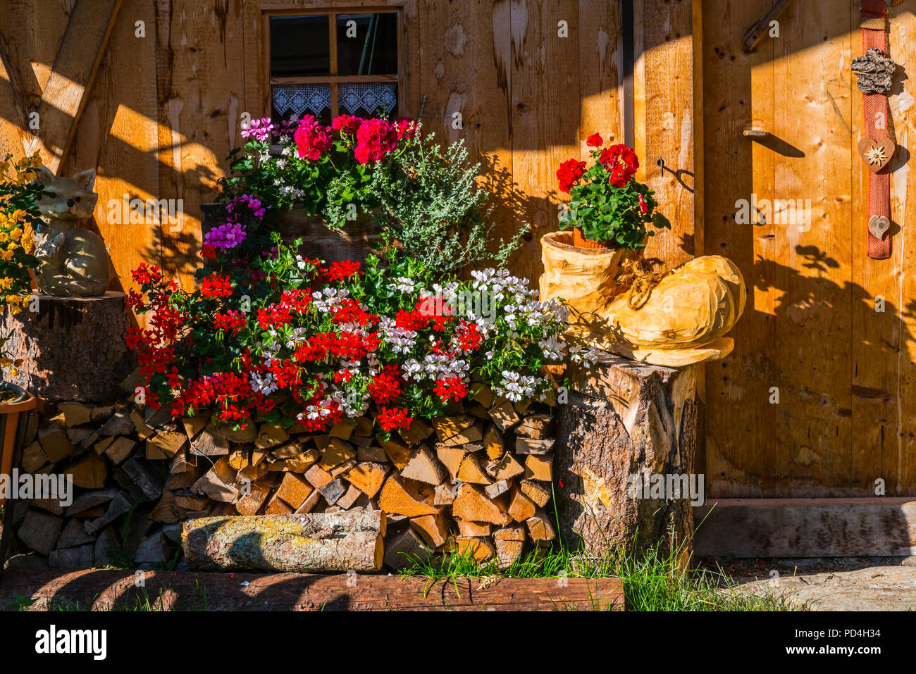 Things Tyrolean with a decorated colourful log-cabin Stock Photo - Alamy