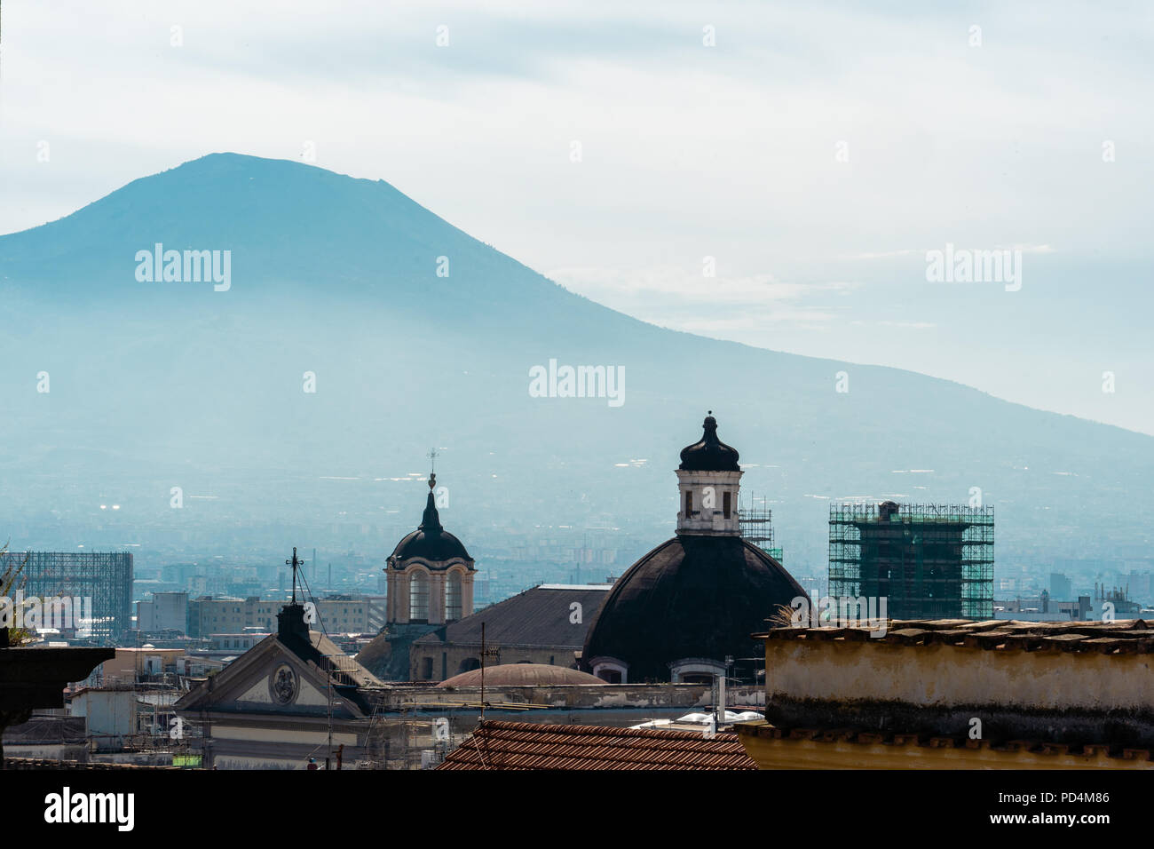 Morning view of Mount Vesuvius over Naples rooftops, dome and spires ...