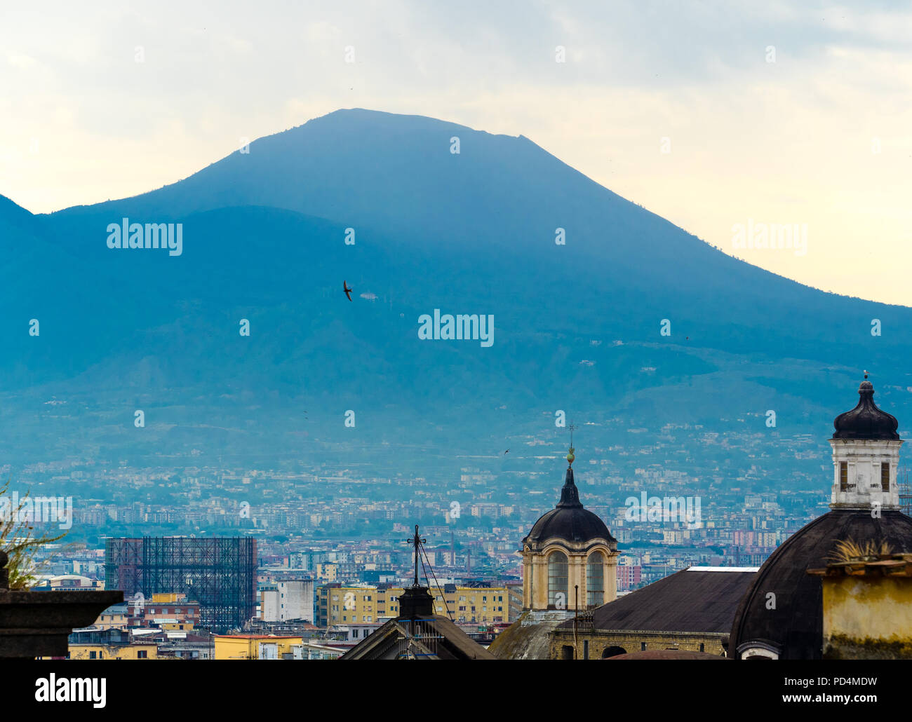 Morning view of Mount Vesuvius over Naples rooftops, dome and spires ...