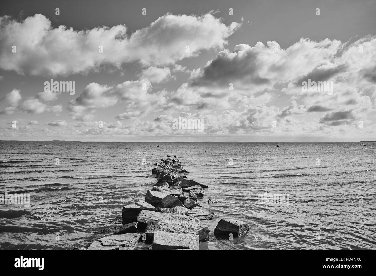 Black and white picture of a rocky breakwater Stock Photo - Alamy
