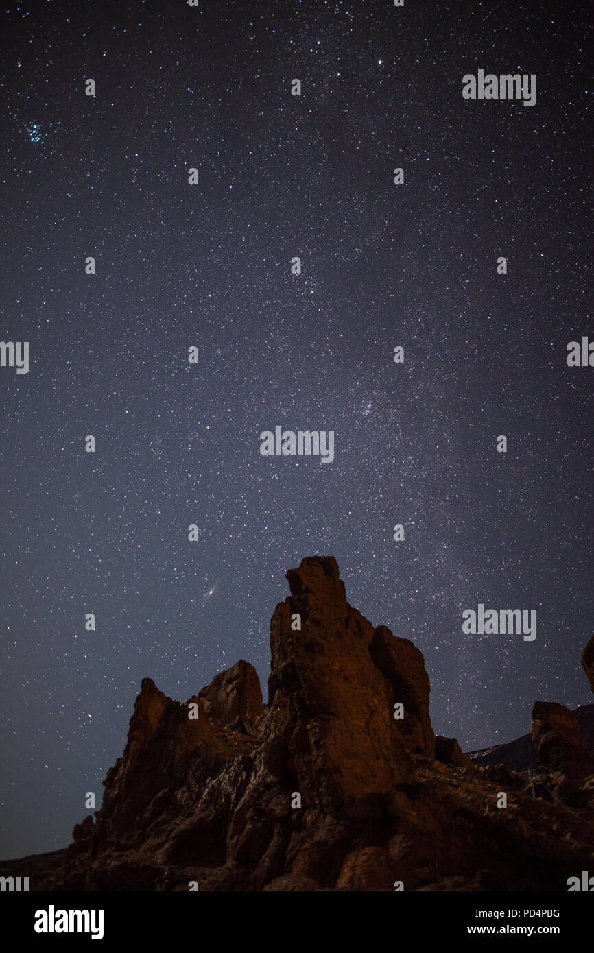 Night sky with shiny stars above mountain Roques de Garcia stone. Milky ...