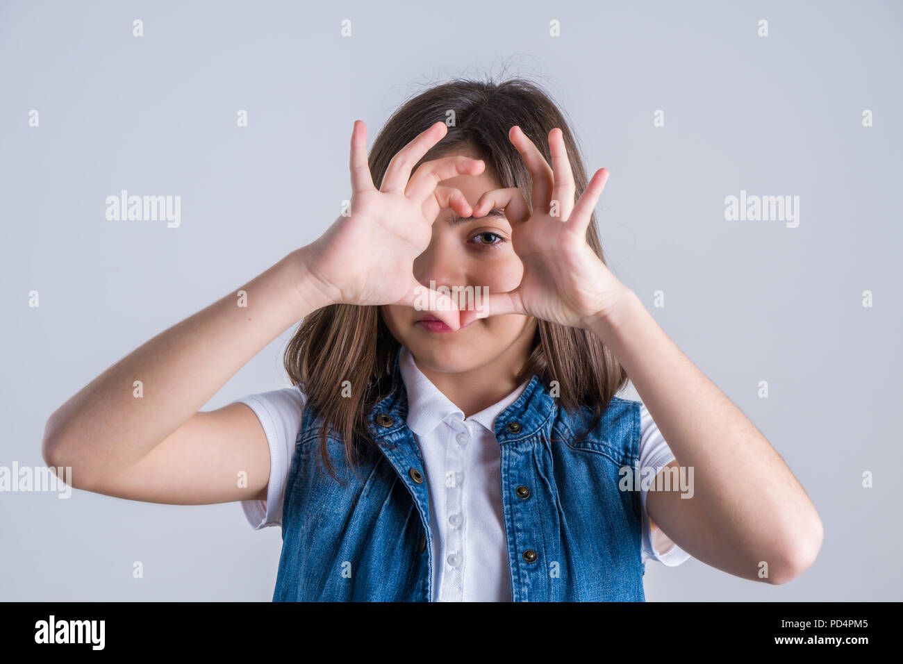 beautiful girl shows heart with fingers, love Stock Photo - Alamy