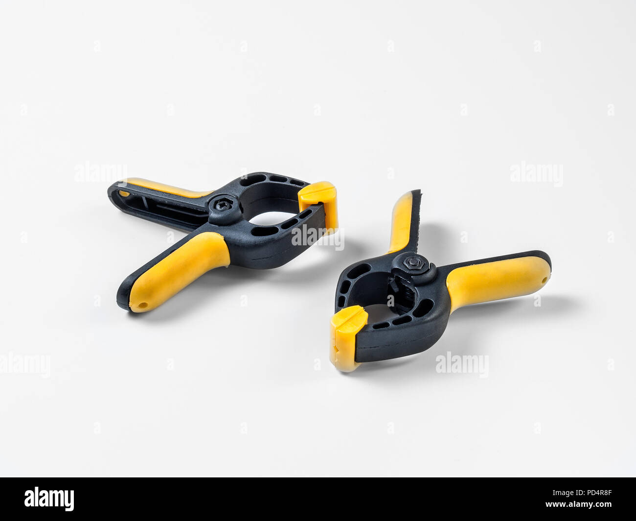 Metallic black with plastic yellow inserts construction clip lies on a ...