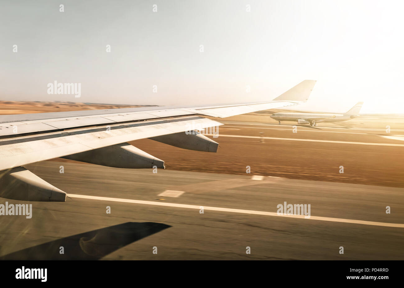 Aerial view out of airplane window while taking off from the runway of ...